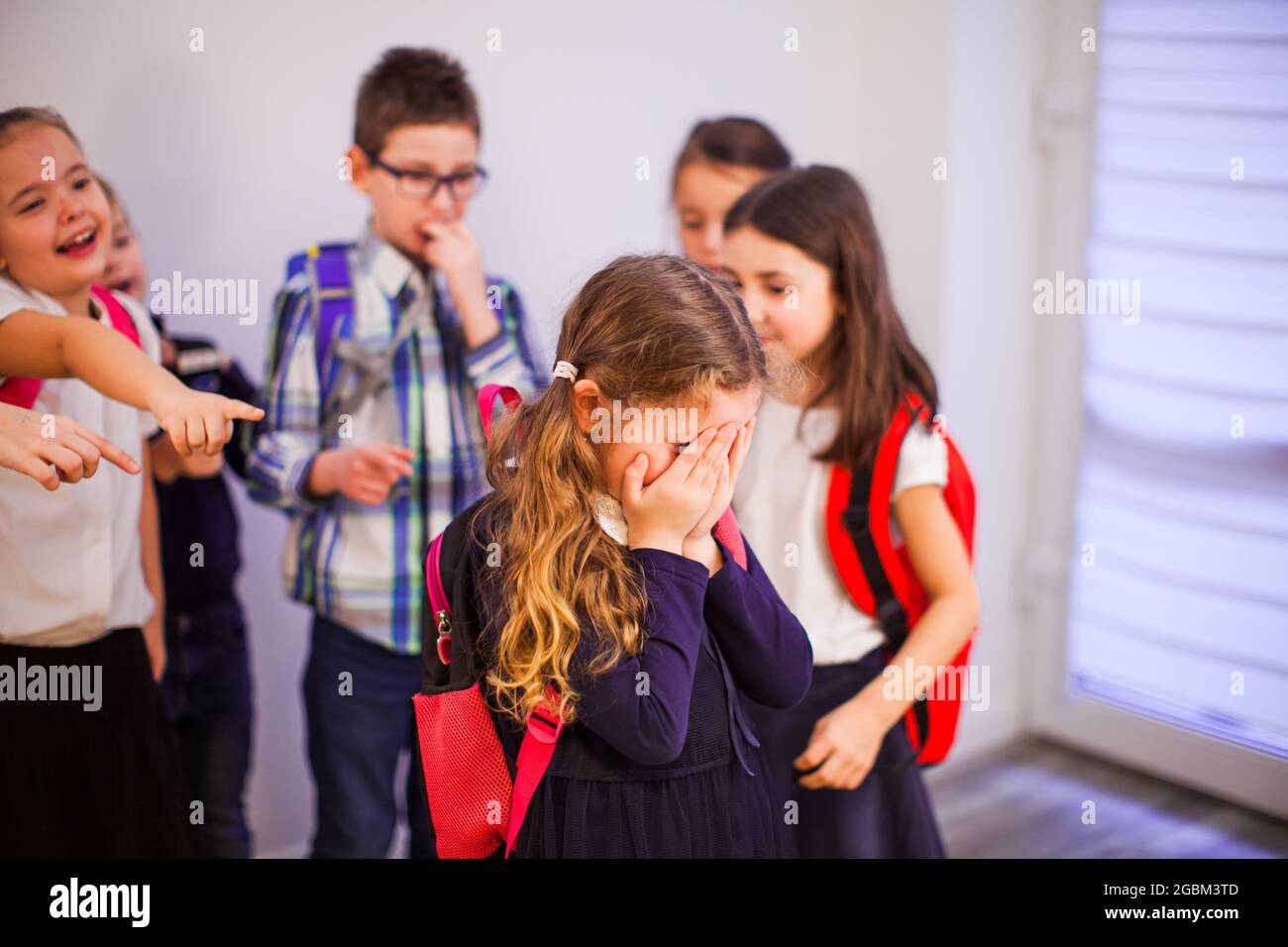 The classmates point to the boy and laugh at him Stock Photo - Alamy