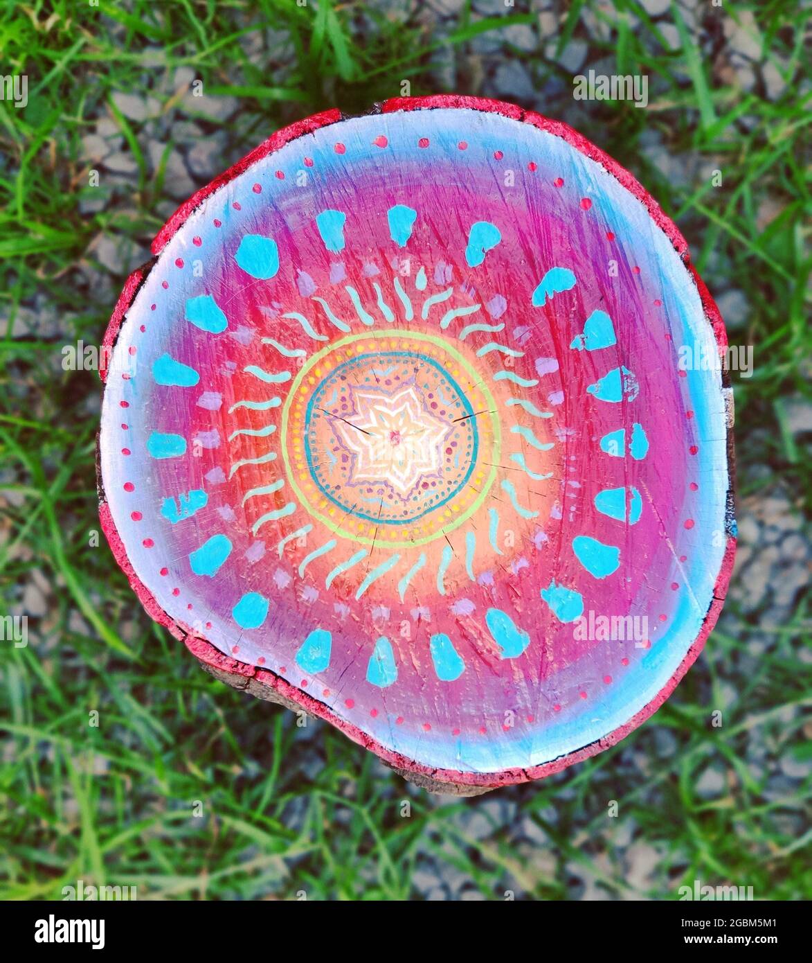 Colorful mandala painted on a tree stump Stock Photo - Alamy