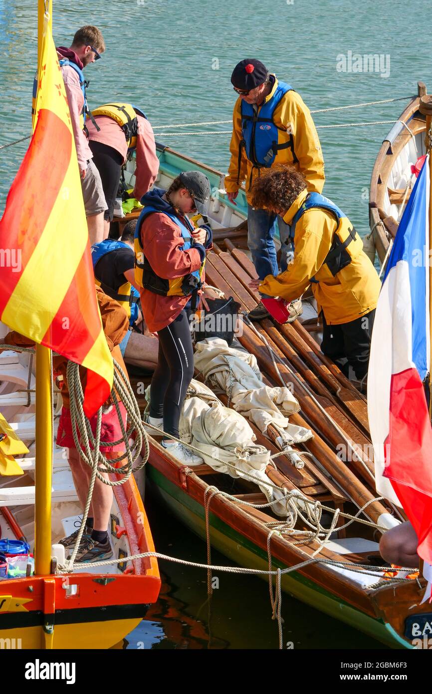 Amateur sailors embarking in vintage sailing barks, Saint-Vaast la ...