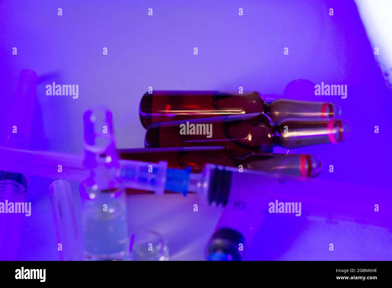 Ampoules on a purple surface in a dark room Stock Photo - Alamy