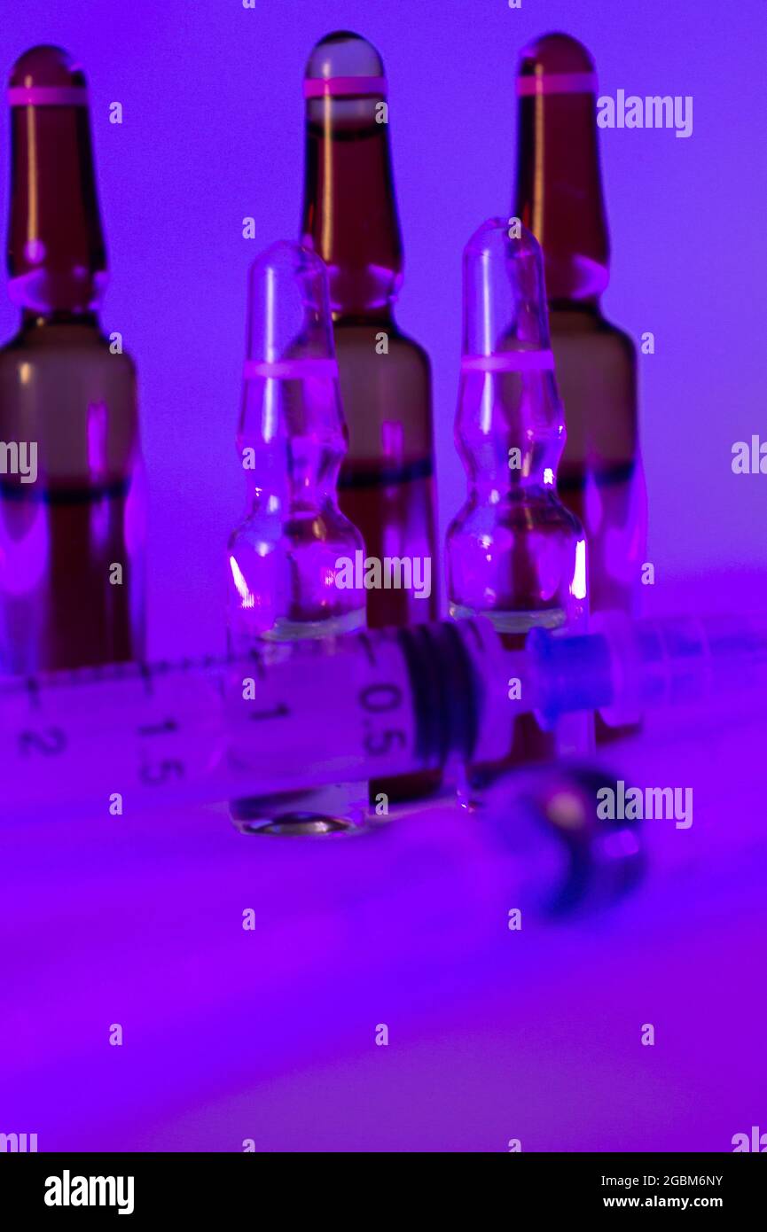 Ampoules on a purple surface in a dark room Stock Photo - Alamy