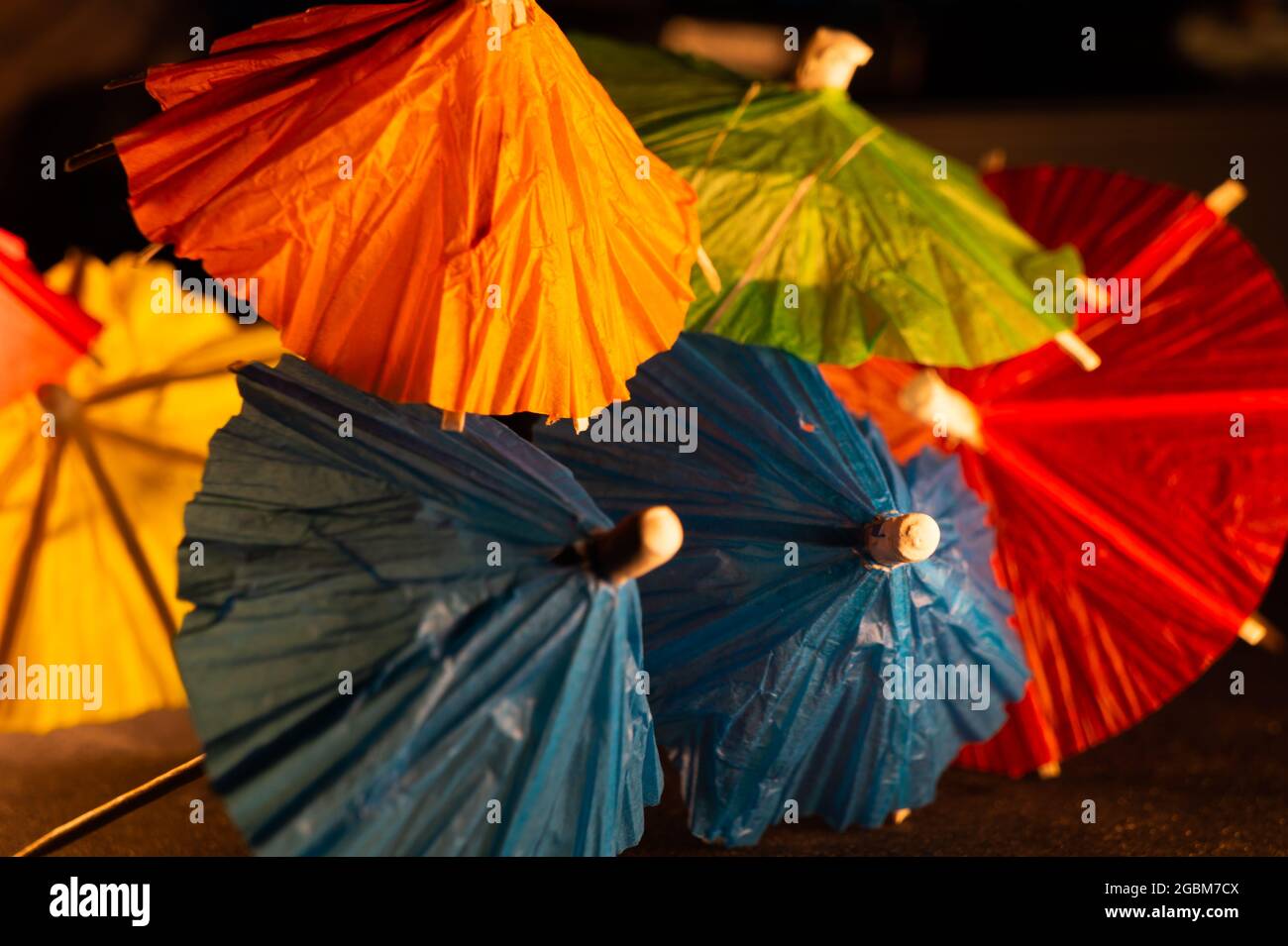 Umbrellas of different colors on a black background Stock Photo - Alamy