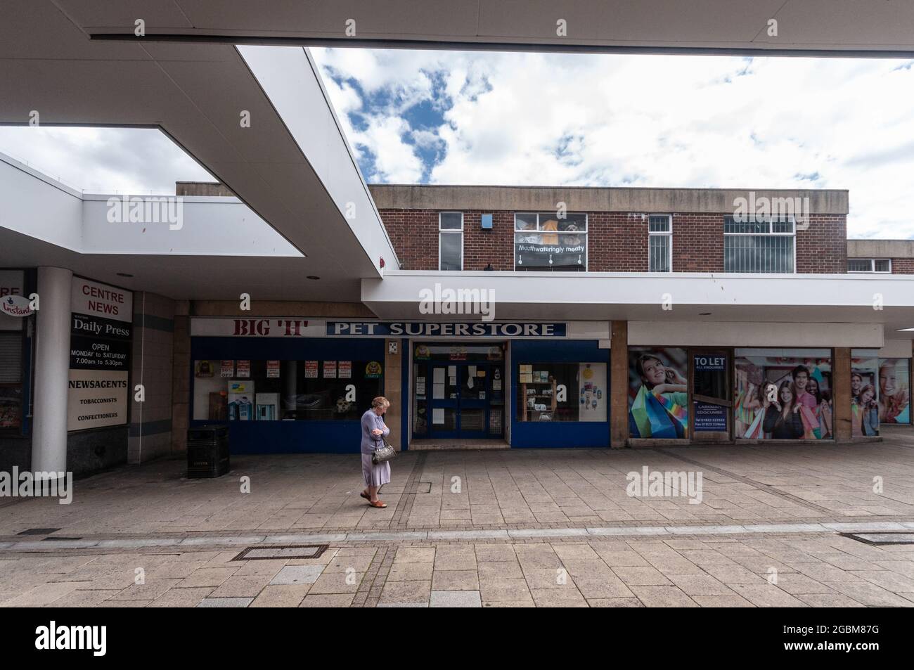 A woman walks past closed shops in the Quedam shopping precinct in ...