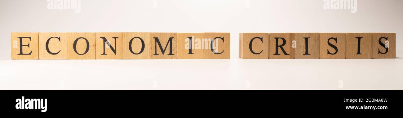The name Economic crisis was created from wooden letter cubes ...