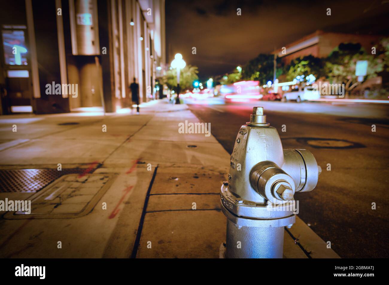 Foreground focus on fire hydrant in city street at night Stock Photo ...