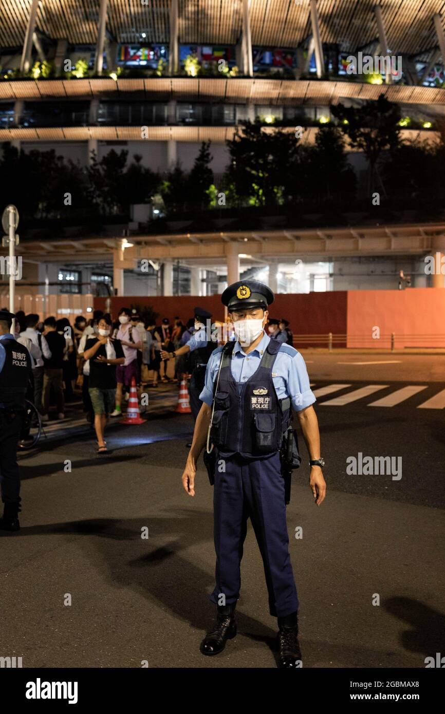 Tokyo, Japan. 23rd July, 2021. A police officer on guard outside the ...