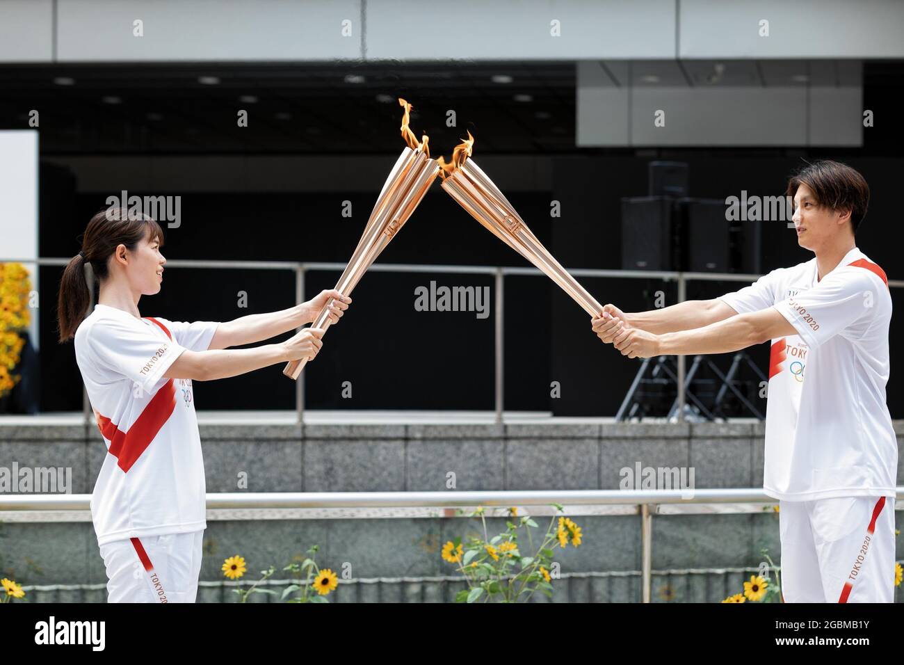 Torchbearers doing the official "Torch kiss" ceremony during the ...