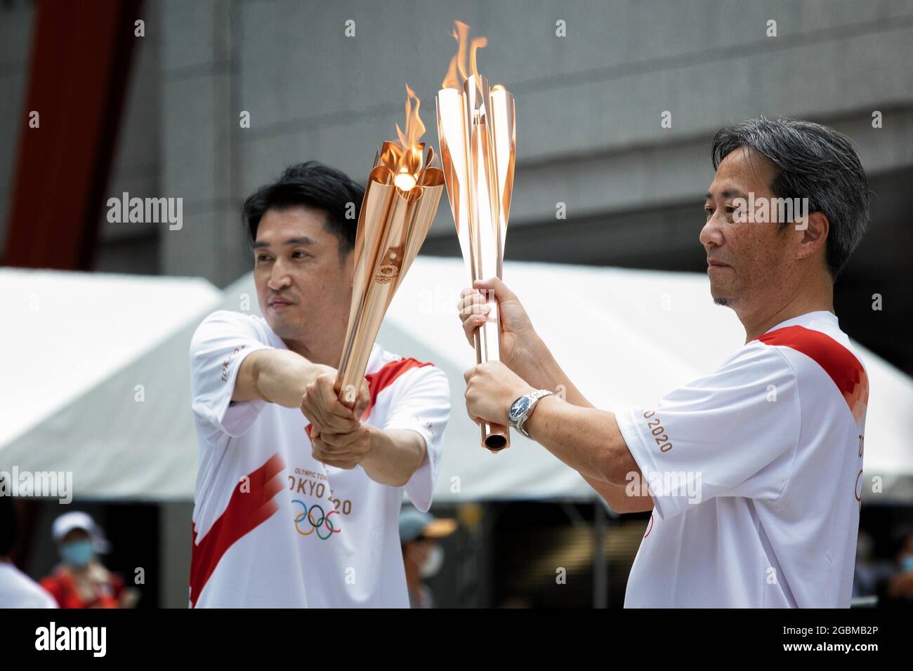 Torchbearers doing the official "Torch kiss" ceremony during the ...
