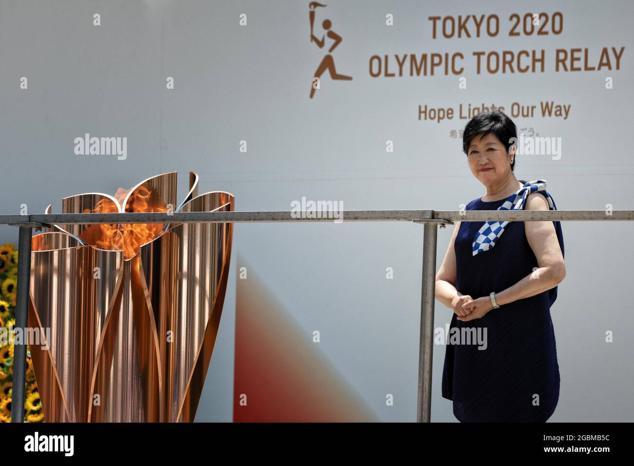 Tokyo Mayor, Koike Yuriko, standing next to the Olympic flame at the ...