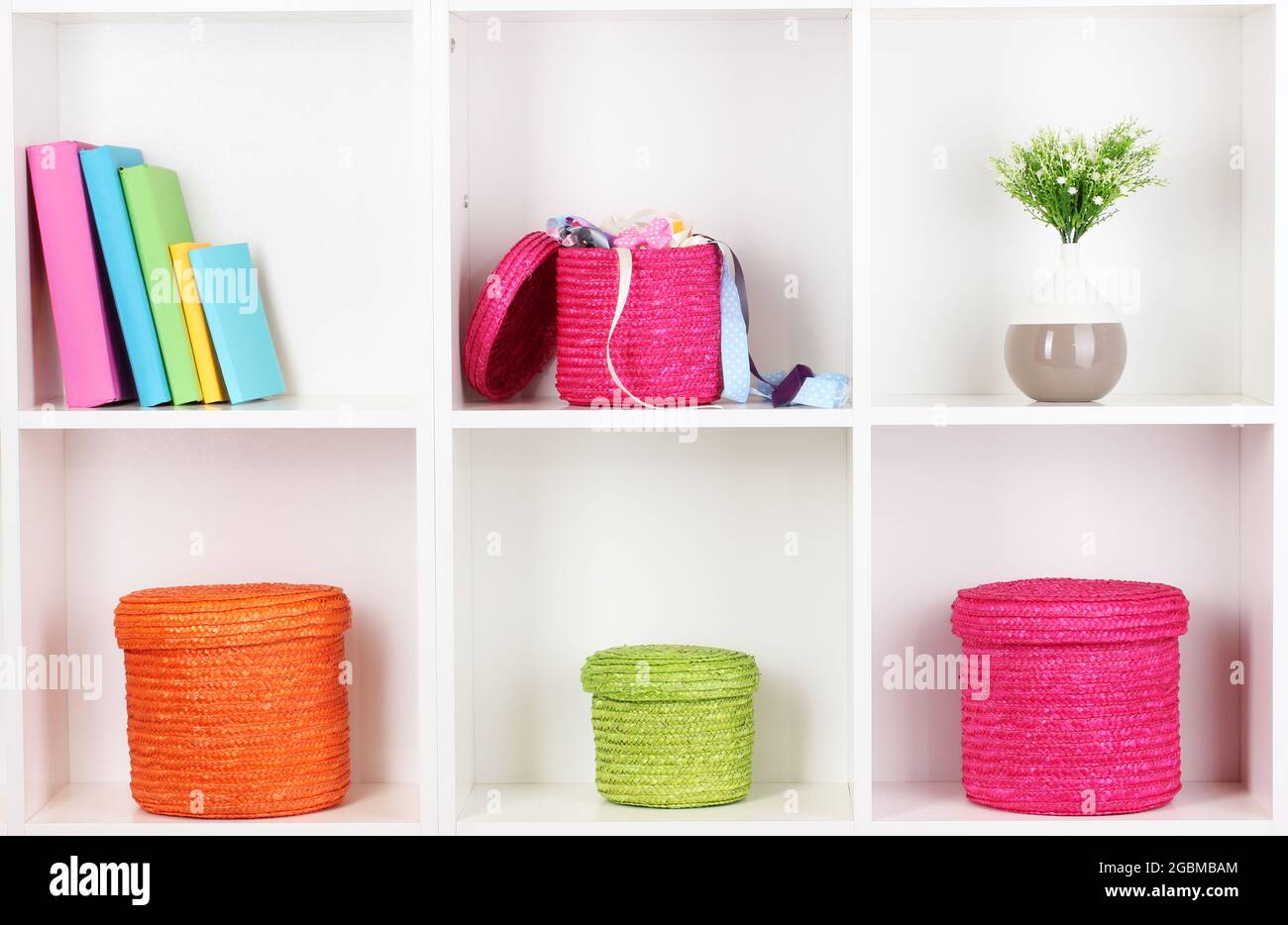 Color wicker boxes on cabinet shelves Stock Photo - Alamy