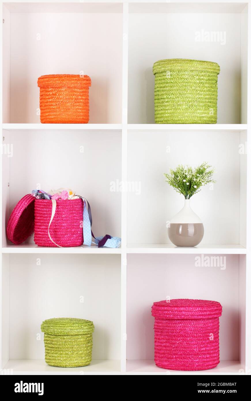 Color wicker boxes on cabinet shelves Stock Photo - Alamy