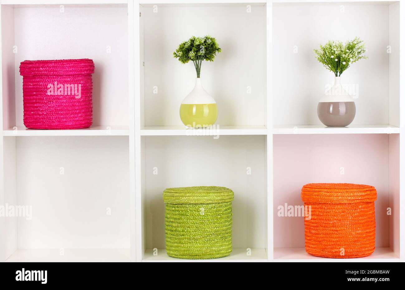 Color wicker boxes on cabinet shelves Stock Photo - Alamy