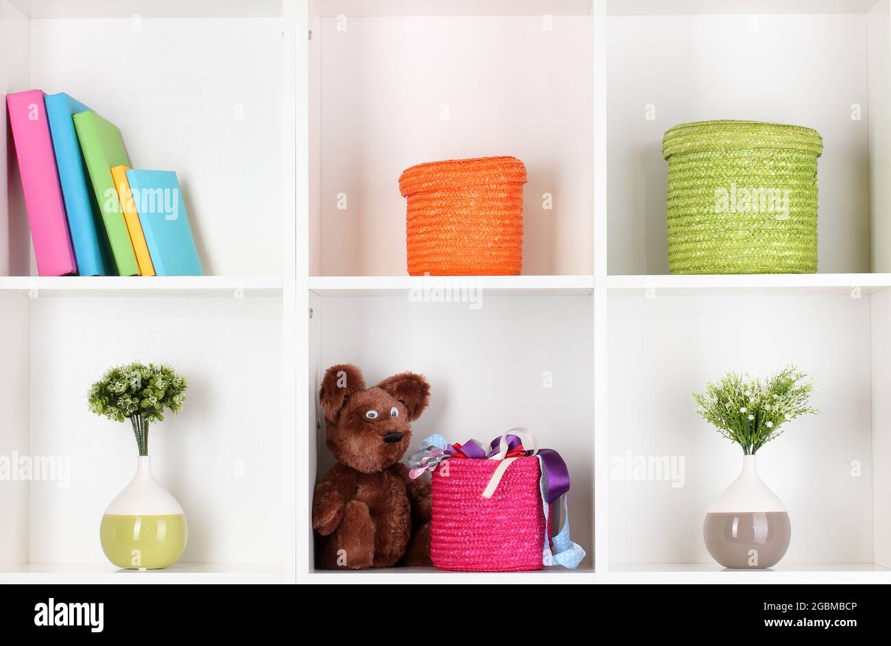 Color wicker boxes on cabinet shelves Stock Photo - Alamy