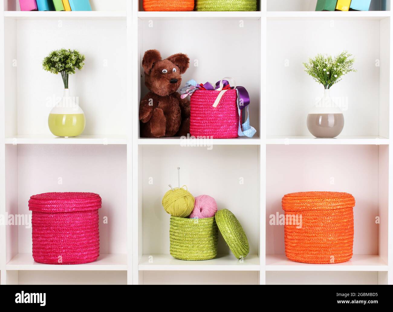 Color wicker boxes on cabinet shelves Stock Photo - Alamy