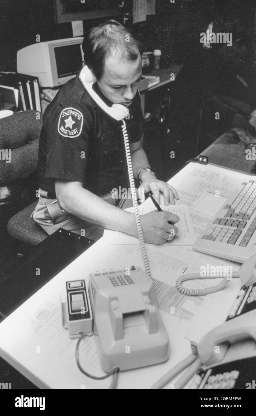 Austin, Texas USA, circa 1991: Travis County Sheriff's officer takes a ...