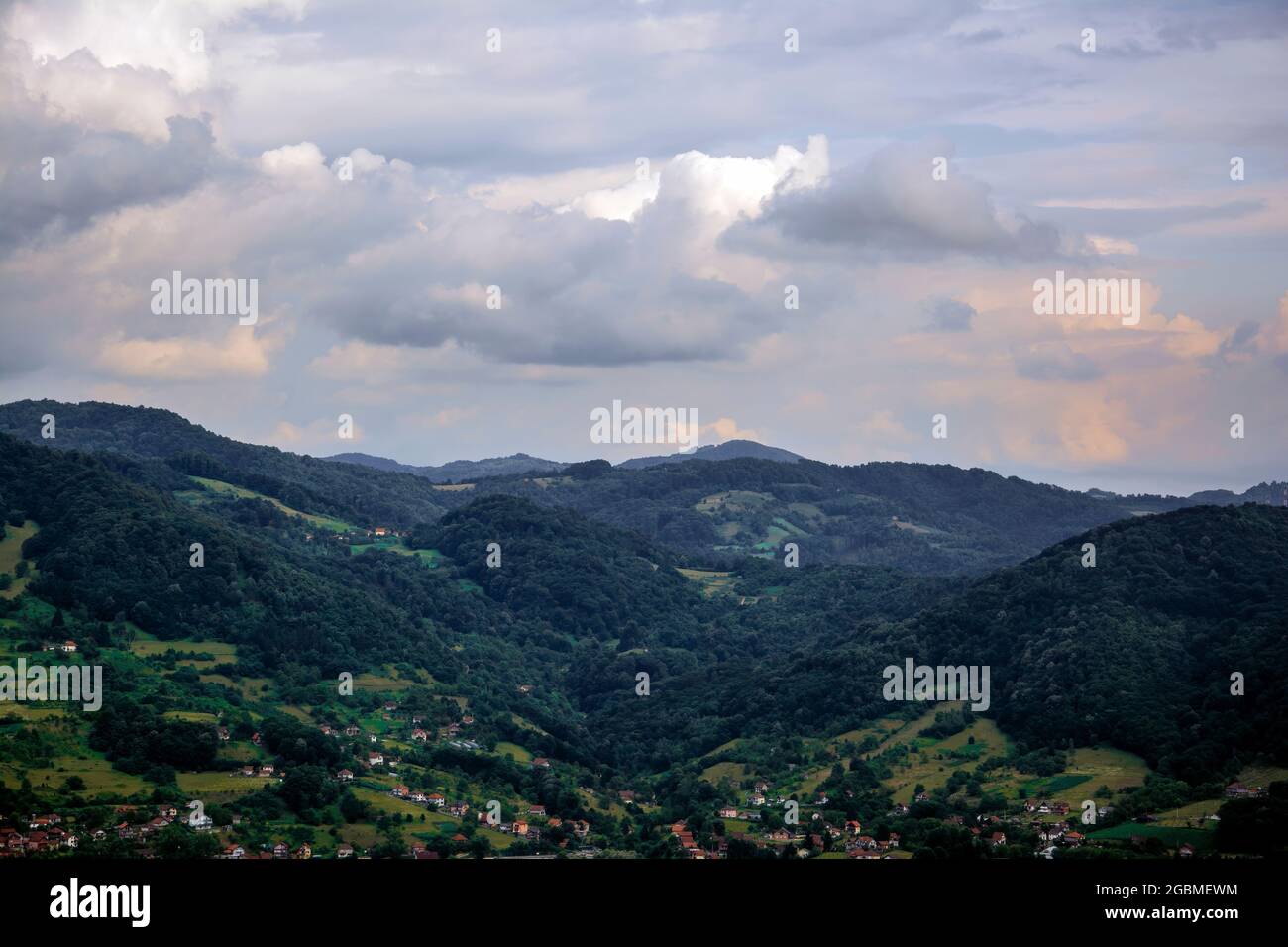 Cloudy sky with distant landscape Stock Photo - Alamy