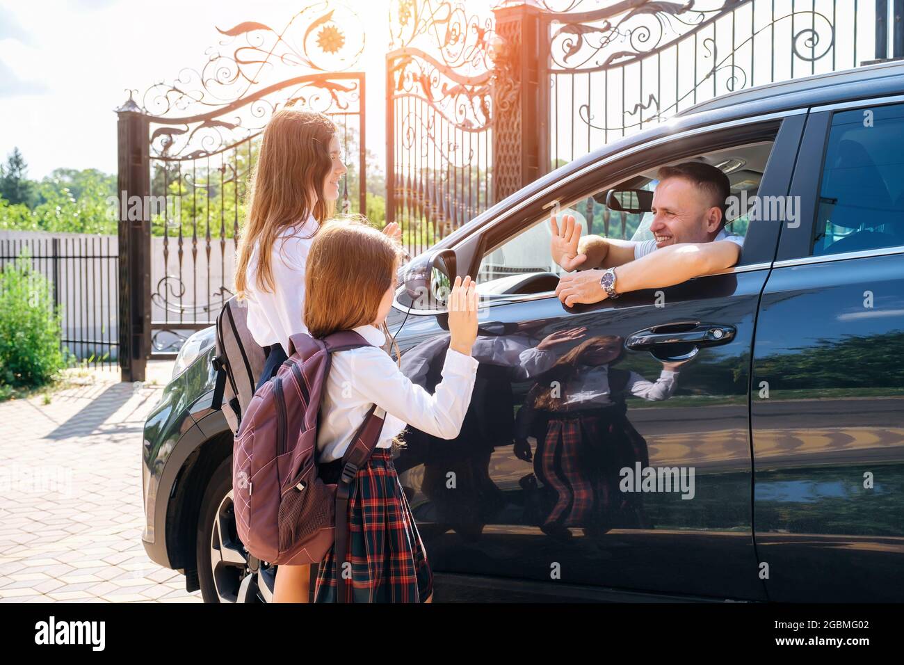Middle-aged father in the car, leaving her daughters at school Stock ...