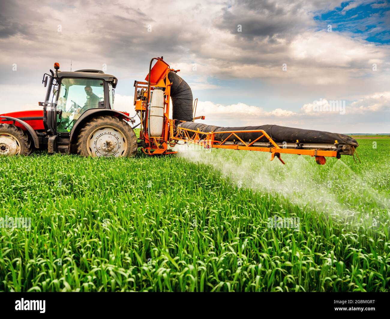 Farmer spraying wheat crops Stock Photo - Alamy