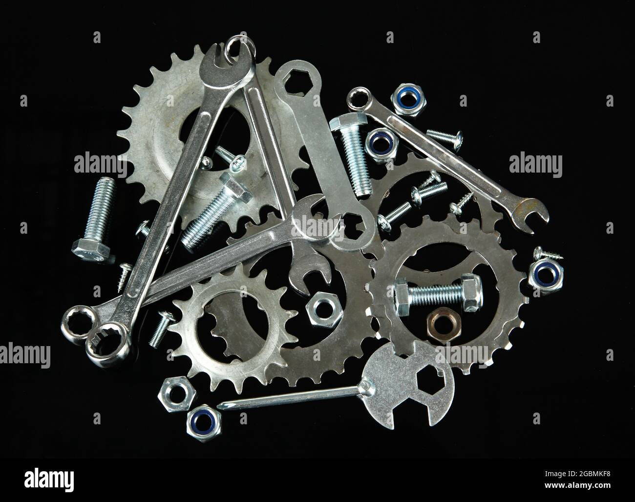Machine gear, metal cogwheels, nuts and bolts isolated on black Stock ...