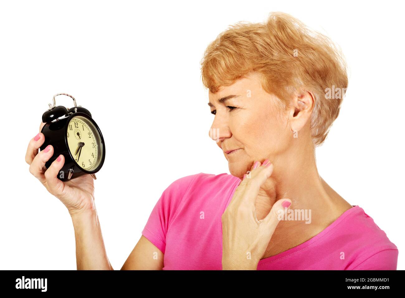 Mature woman looking alarm clock hi-res stock photography and images ...