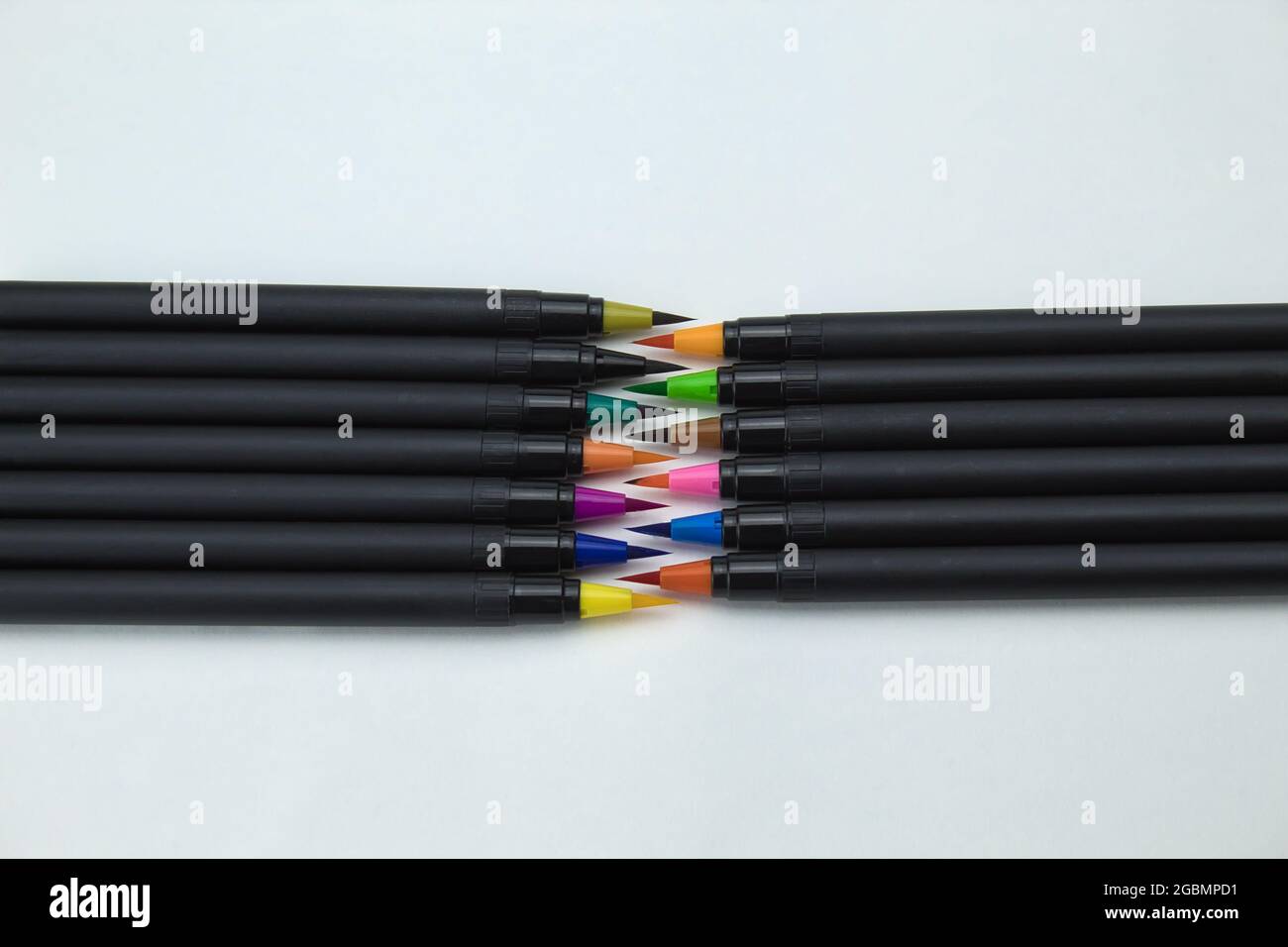 foreground of set of colored self-tips pens and markers on white ...