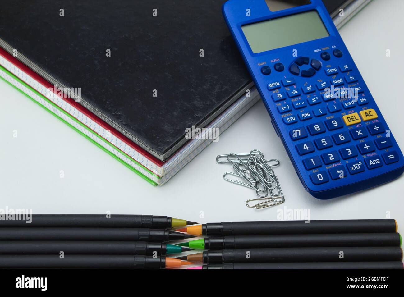 group of school tools with notebooks, markers, pens, clips and ...
