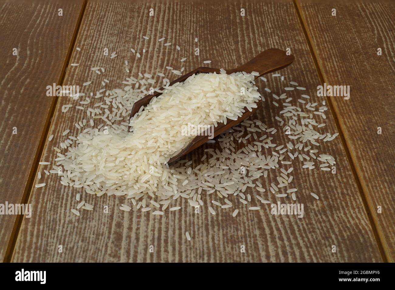 raw white rice on dark rustic wooden background Stock Photo - Alamy