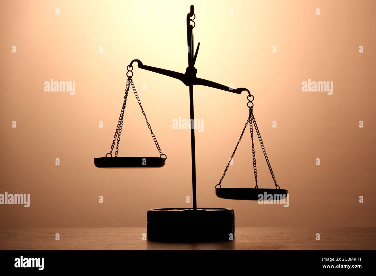 Gold scales of justice on brown background Stock Photo - Alamy