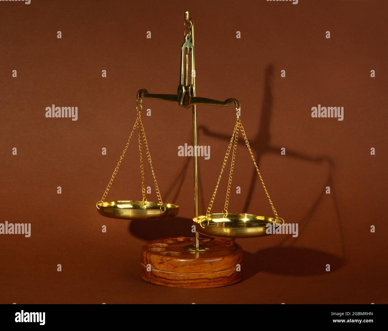 Gold scales of justice on brown background Stock Photo - Alamy