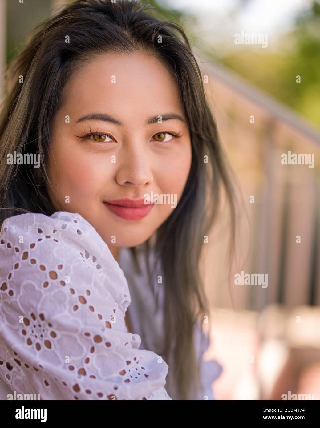 Portrait of a Young Asian Woman in a White Summer Dress Seated on ...