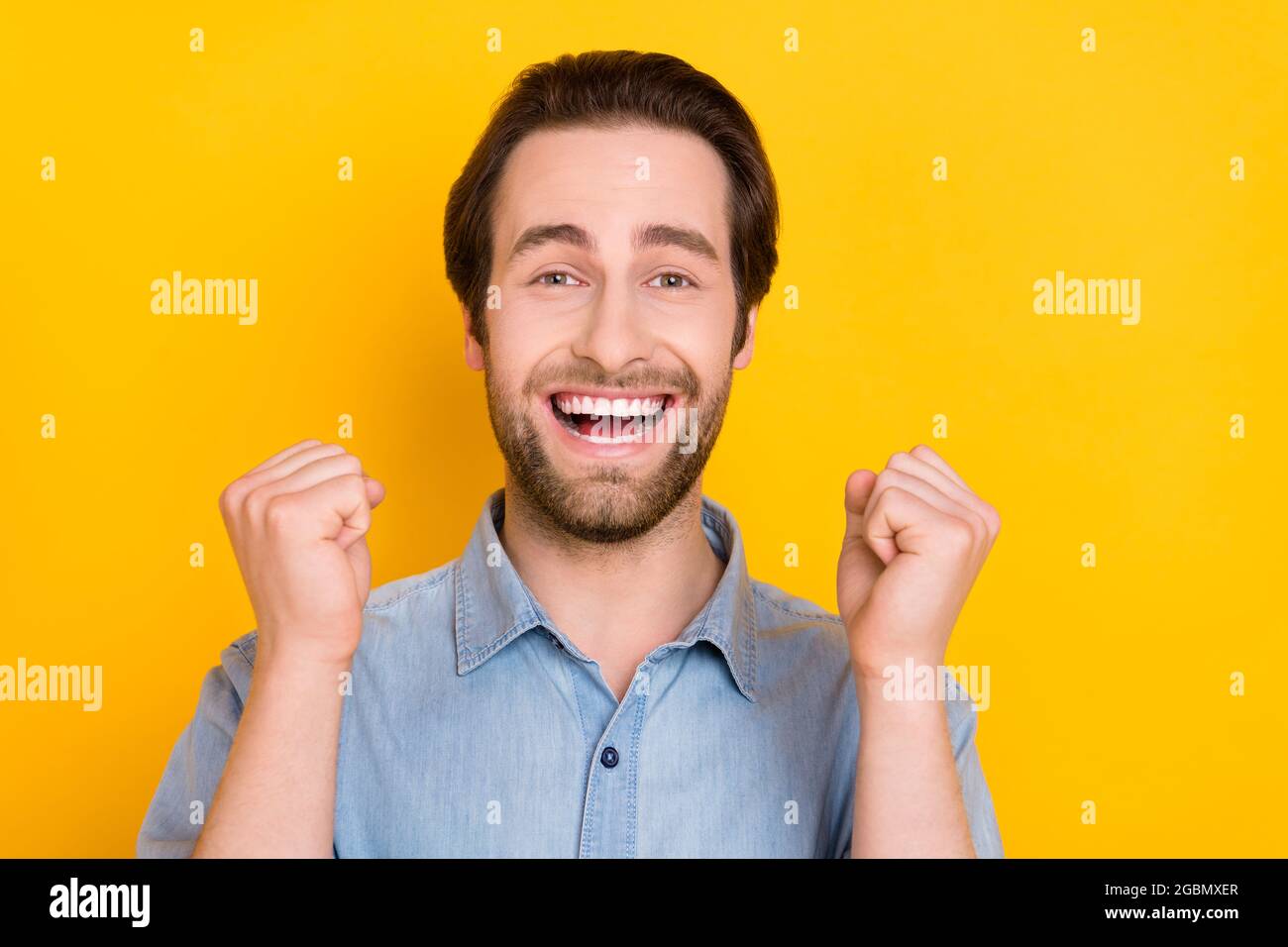 Photo portrait of young guy overjoyed gesturing like winner laughing ...