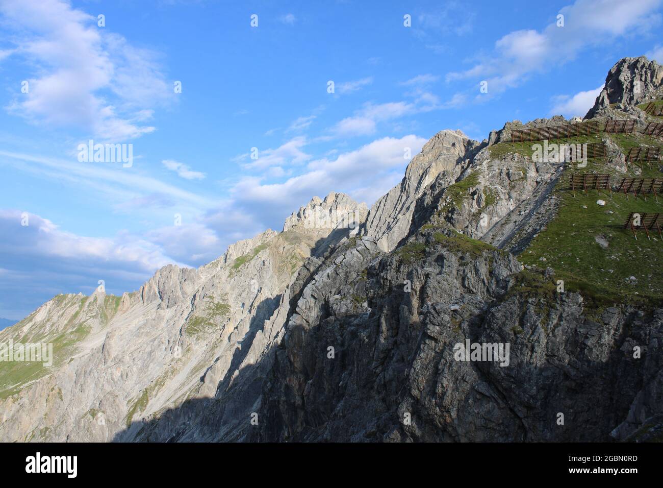 Shot of mountains under the sunlight on the blue cloudy background ...