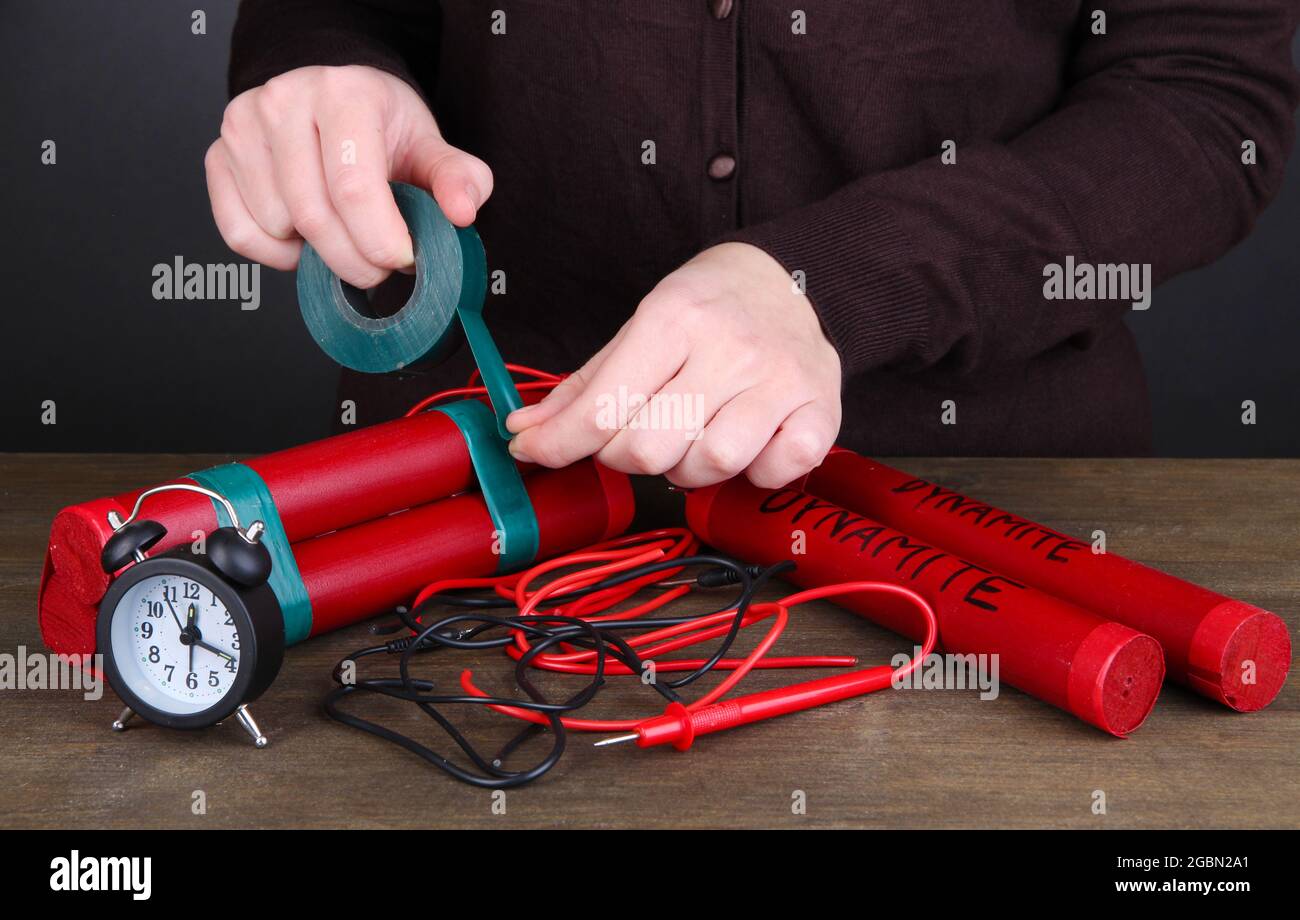 Human makes timebomb on wooden table on black background Stock Photo ...