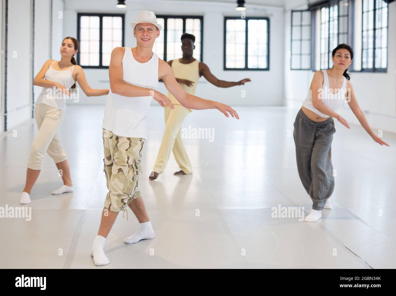 Four dancers exercising contemporary dance movements Stock Photo - Alamy