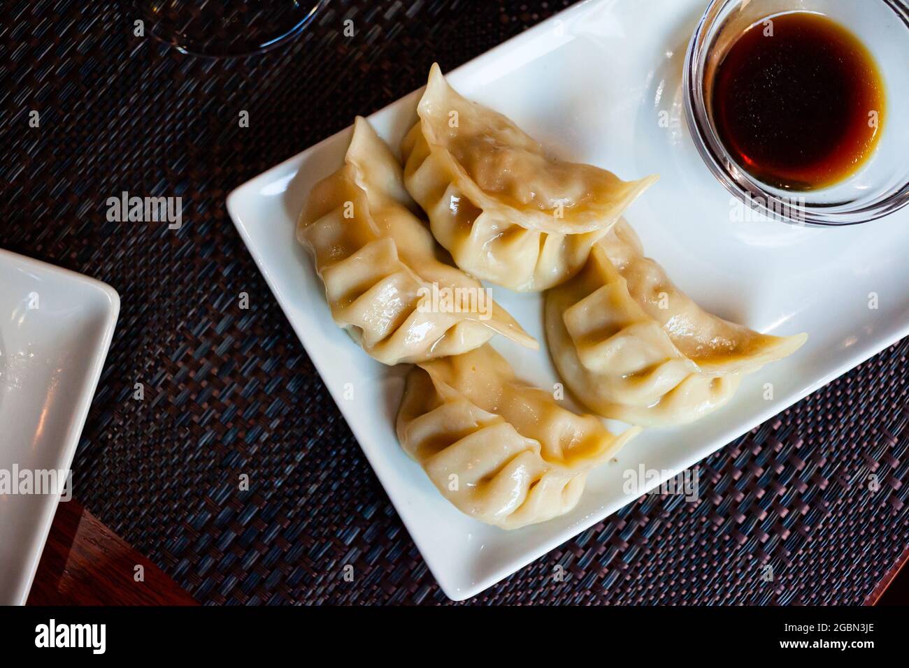 Japanese dish - dumplings gyoza with soy sauce on white plate Stock ...
