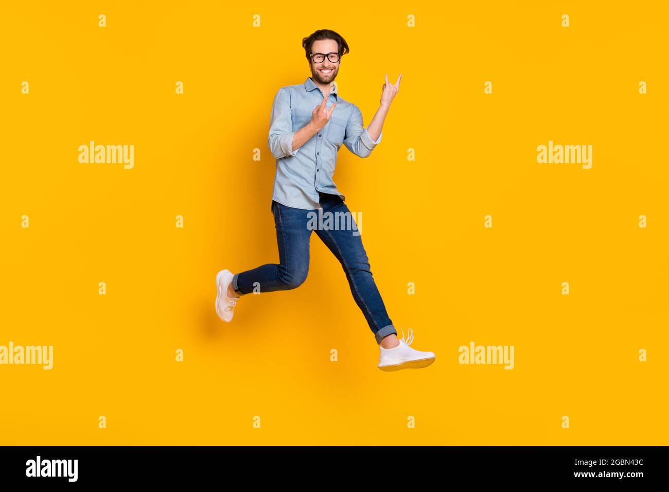 Full size photo of young excited man happy positive smile show rock ...