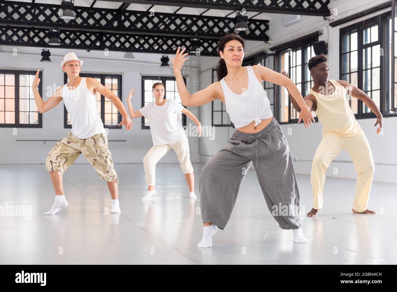 Four dancers exercising contemporary dance movements Stock Photo - Alamy