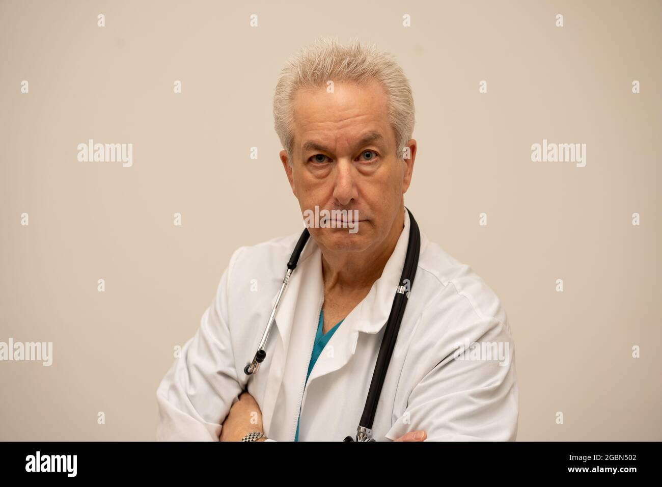 Doctor giving a serious look at camera Stock Photo - Alamy