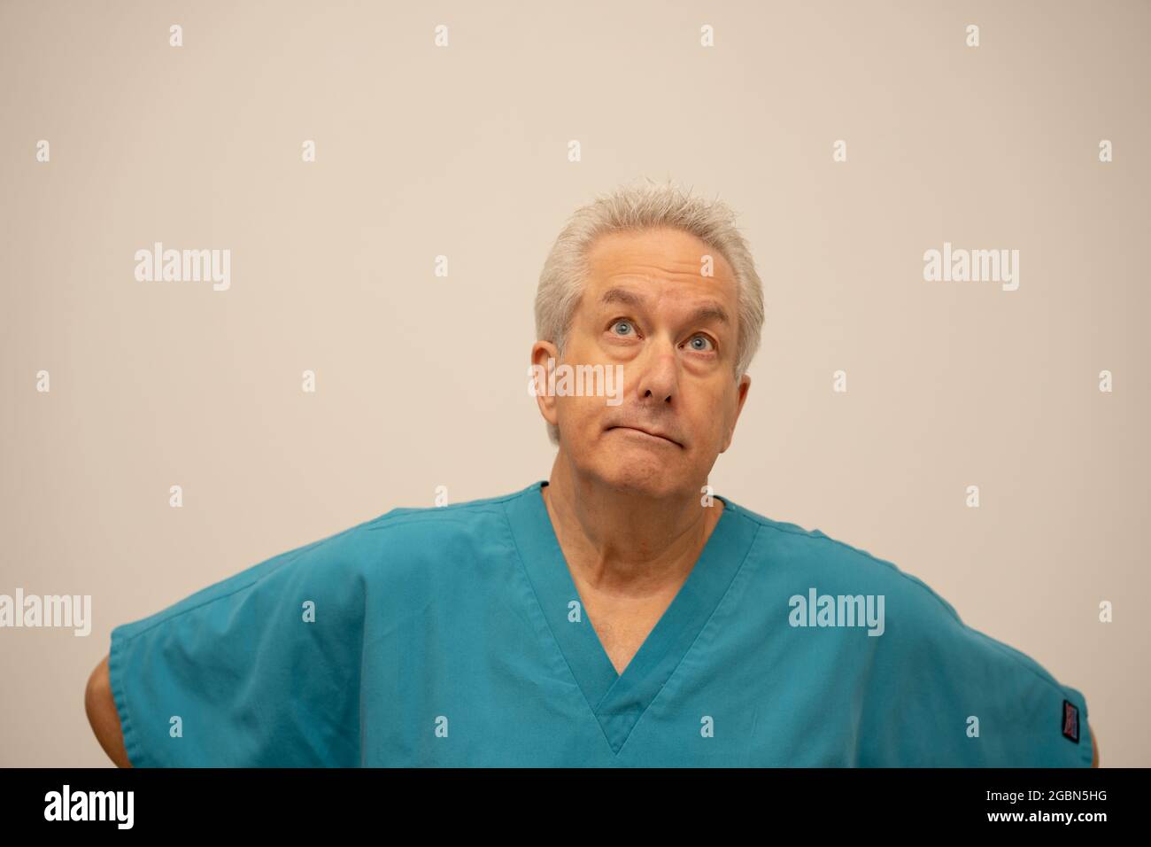 Photo of a doctor looking sideways away from camera Stock Photo - Alamy