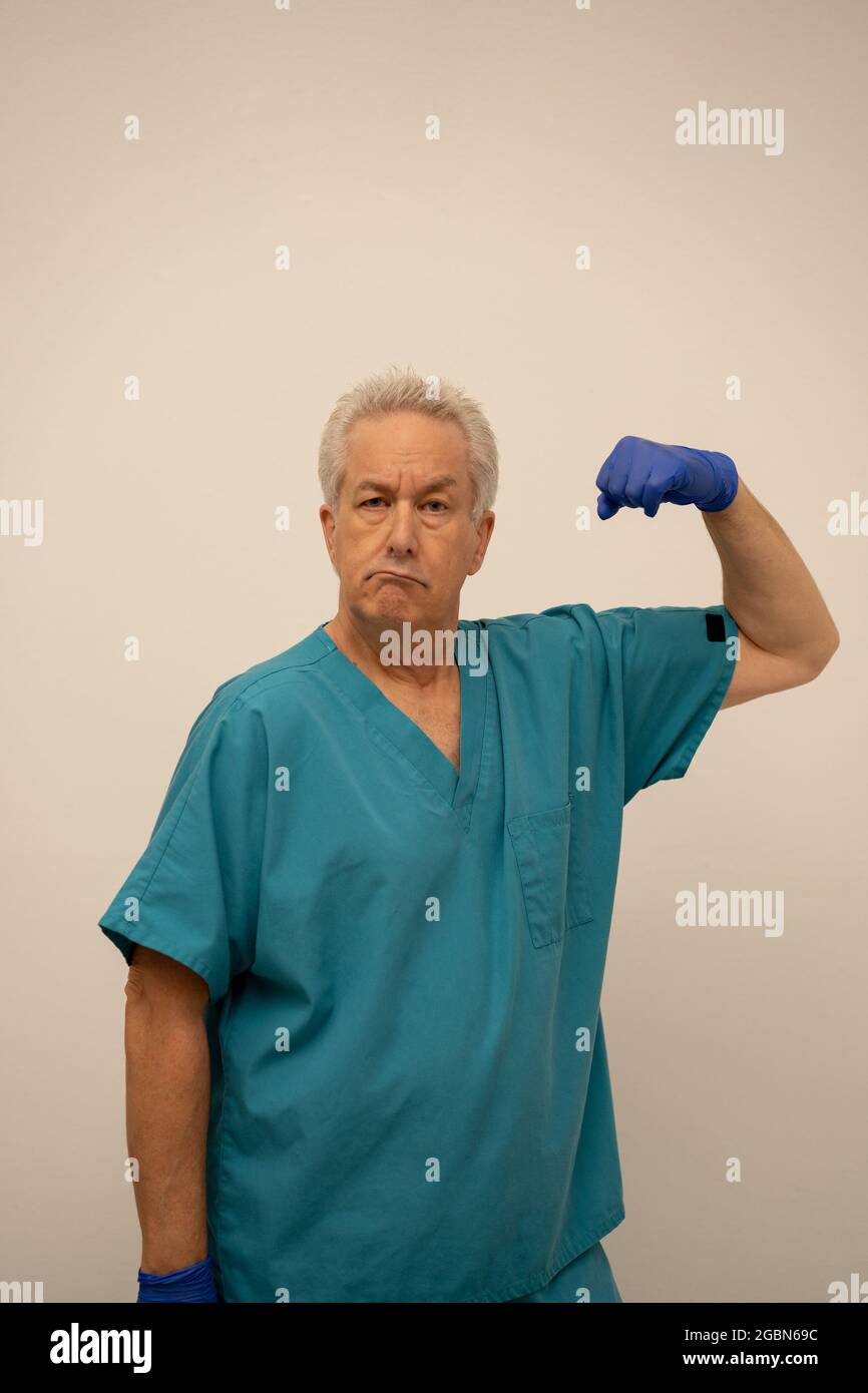 Doctor flexing his muscles Stock Photo - Alamy