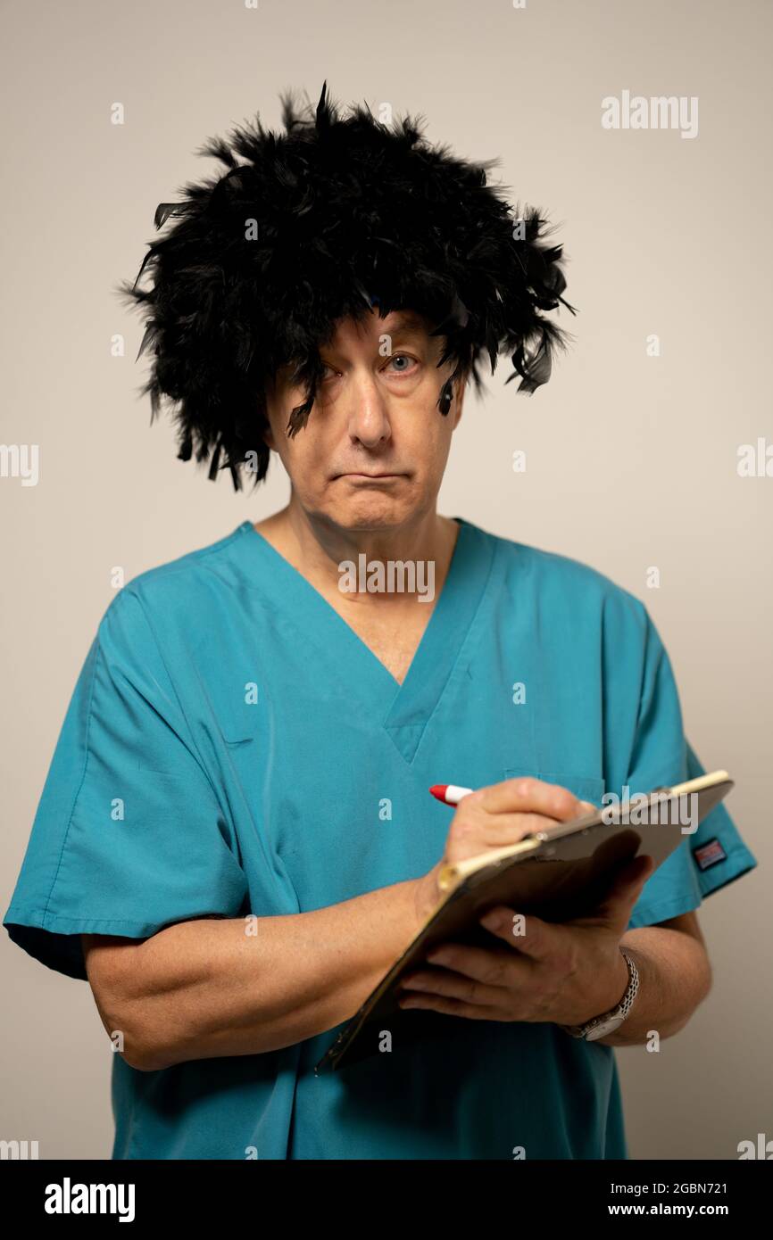 Male nurse with crazy hair taking notes on a note pad Stock Photo - Alamy
