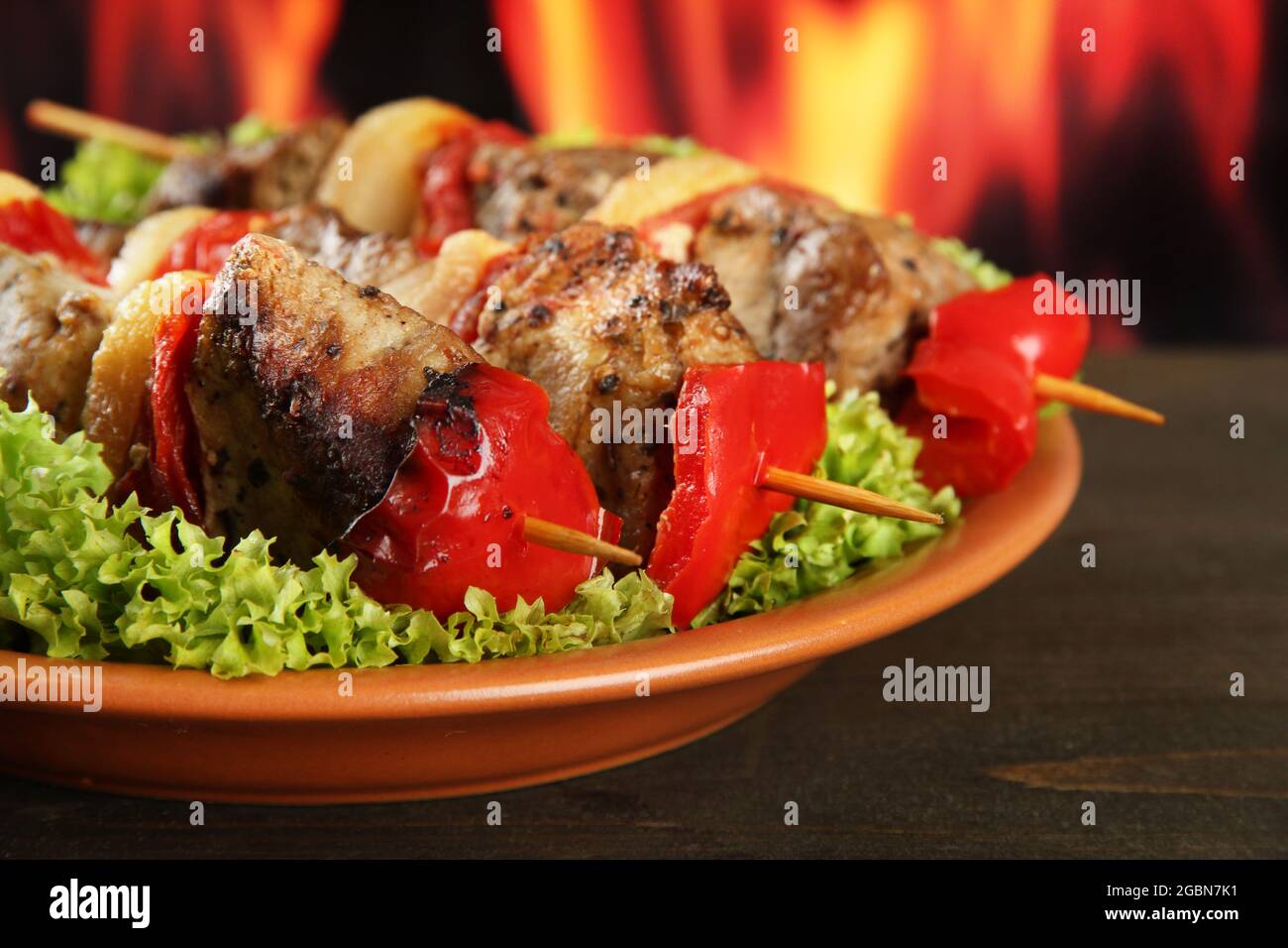 tasty grilled meat and vegetables on plate, on fire background Stock ...