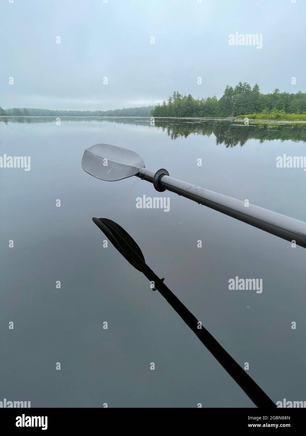 Kayak Paddle Reflection on Calm Lake Stock Photo - Alamy