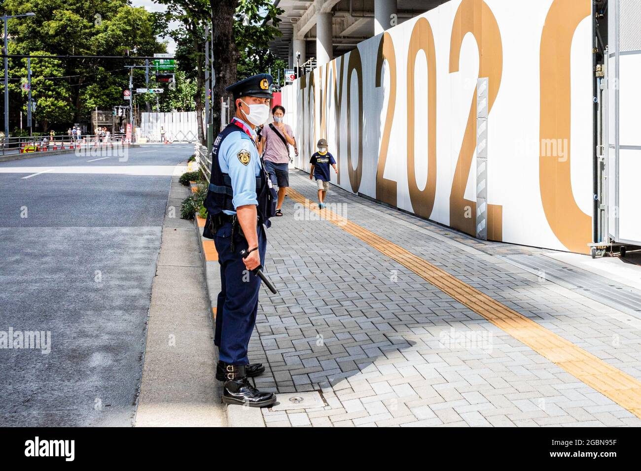 A policeman standing on guard outside the Tokyo National Olympic ...