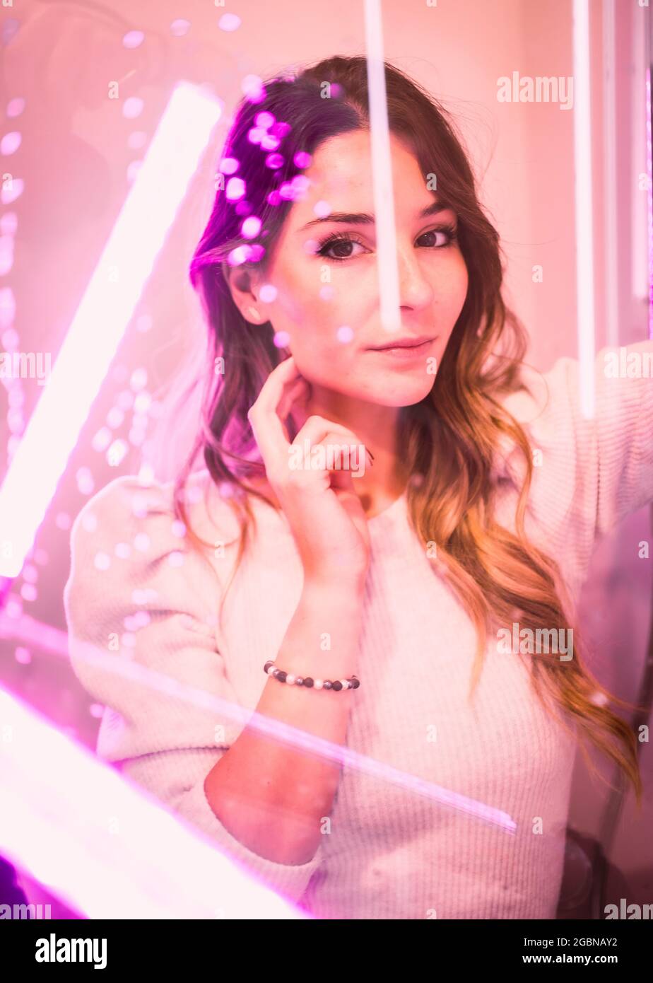 Vertical shot of a young Caucasian woman looking into the camera with ...