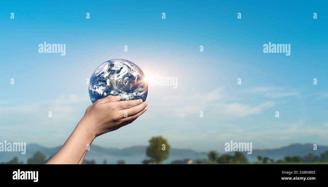 Hands holding Globe, Earth on nature sky background. Elements of this ...