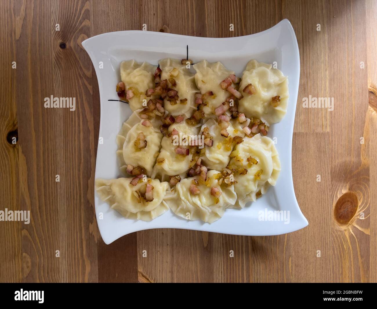 Top view of an abstract ceramic plate with dumplings, meat and fried ...