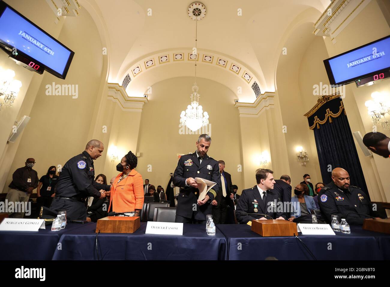 From left, Sgt. Aquilino Gonell of the US Capitol Police shakes hands ...