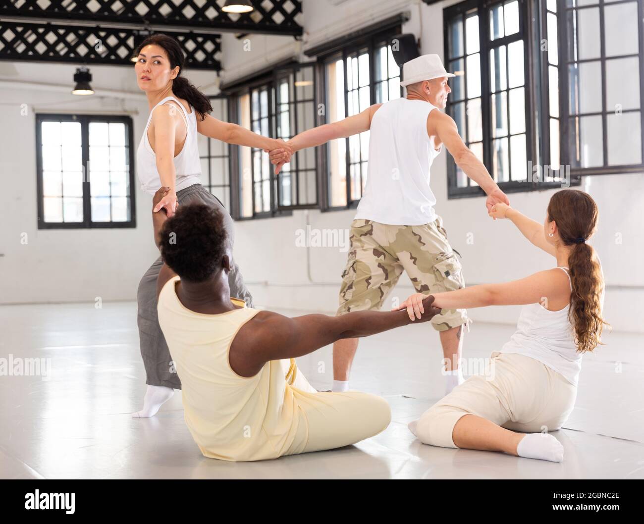 Four artists playing art performance Stock Photo - Alamy
