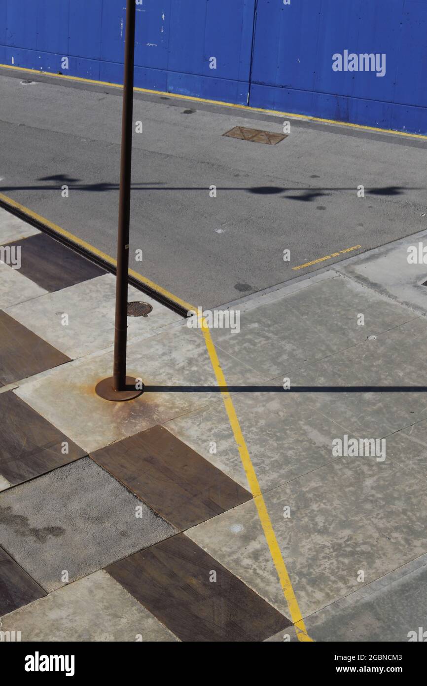 Vertical shot of a rusty pole on the pavement under the sunlight Stock ...